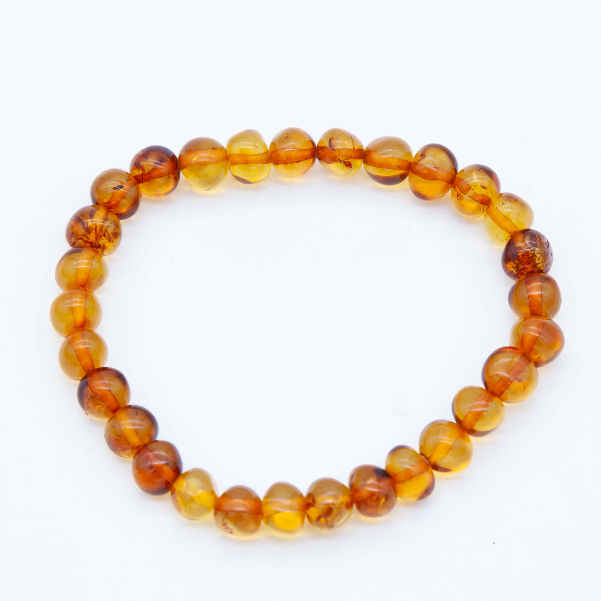 1AC925-B1: Amber Stretch Bracelet Round Nuggets Honey – Shipwreck Beads
